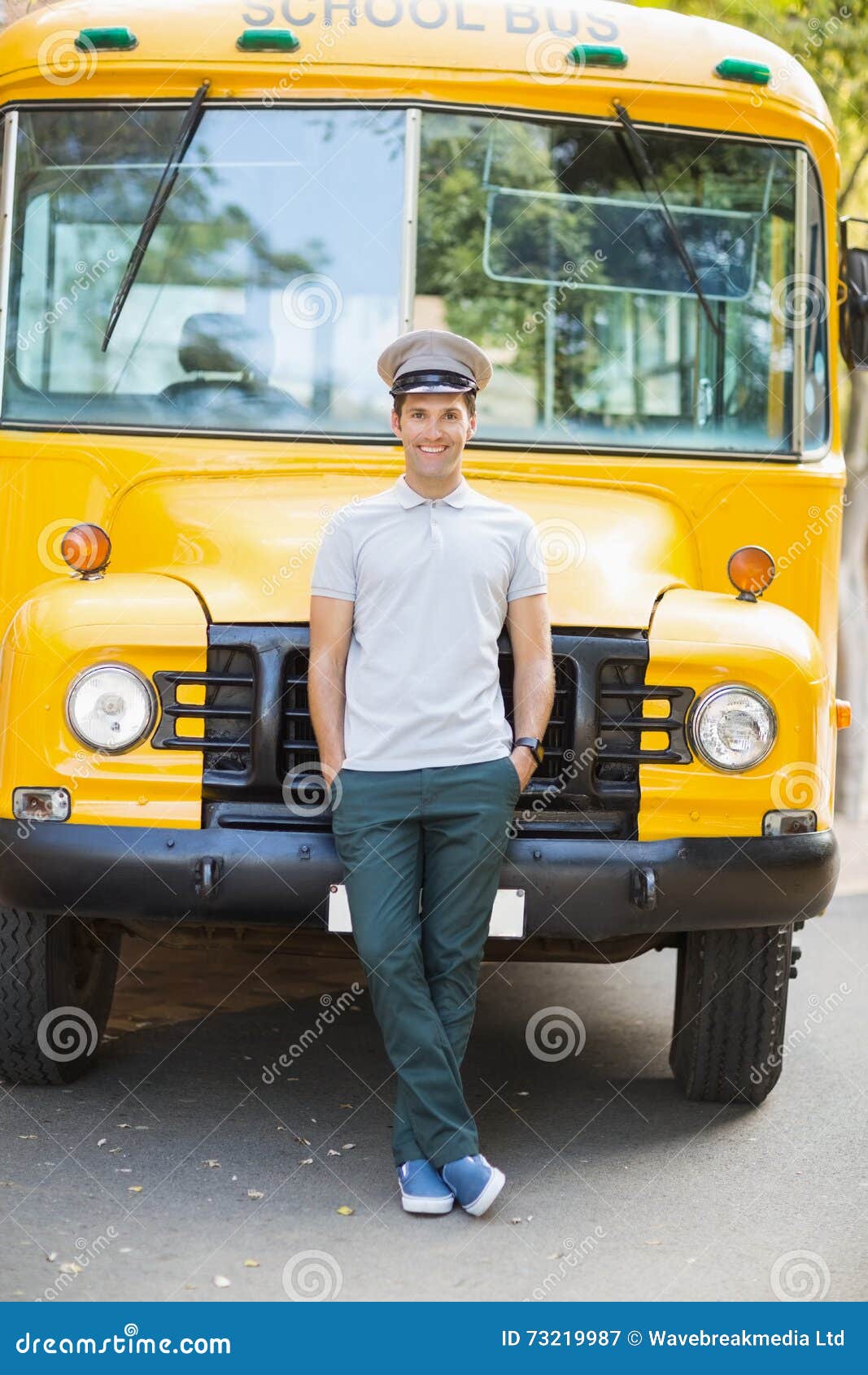Smiling Bus Driver Leaning with Hands in Pocket in Front of Bus Stock ...