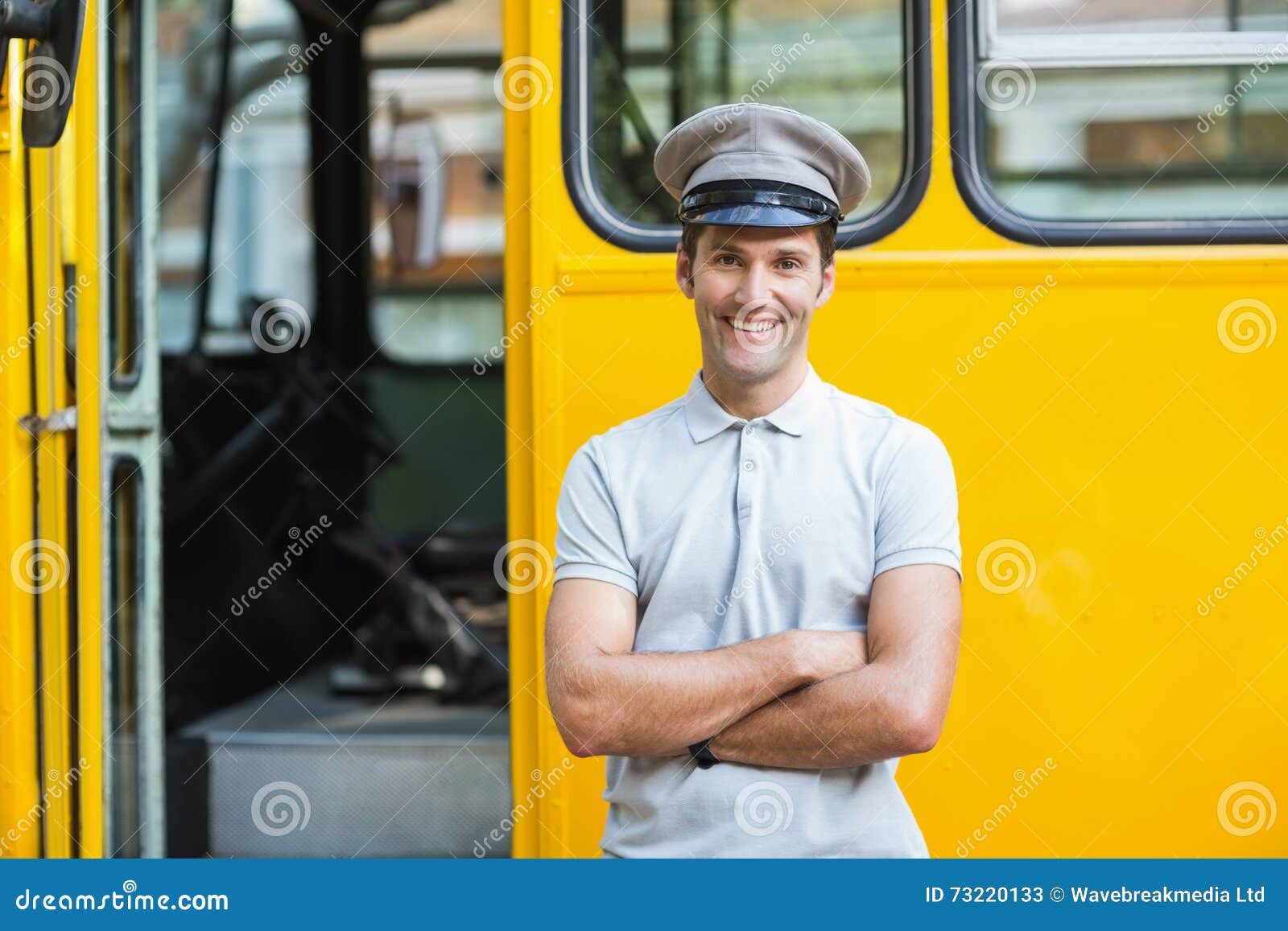 Smiling Bus Driver Standing with Arms Crossed in Front of Bus Stock ...