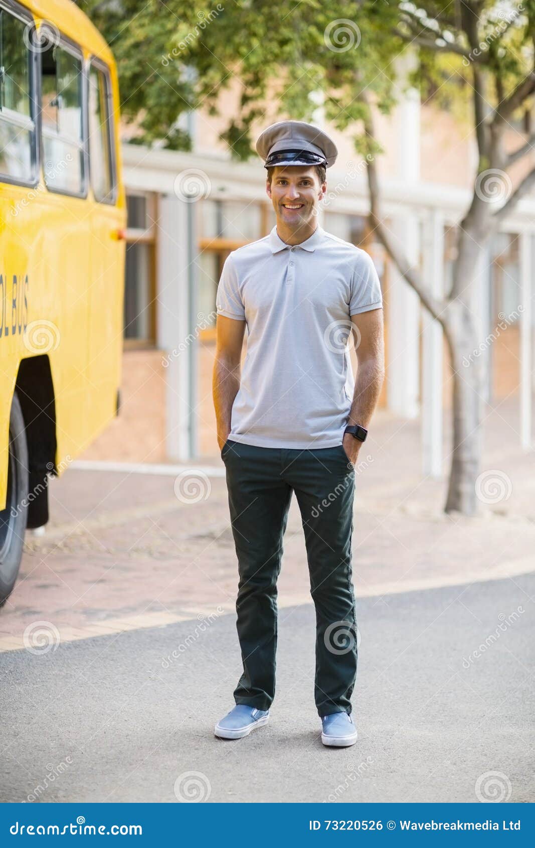 Smiling Bus Driver Standing with Hands in Pocket in Front of Bus Stock ...