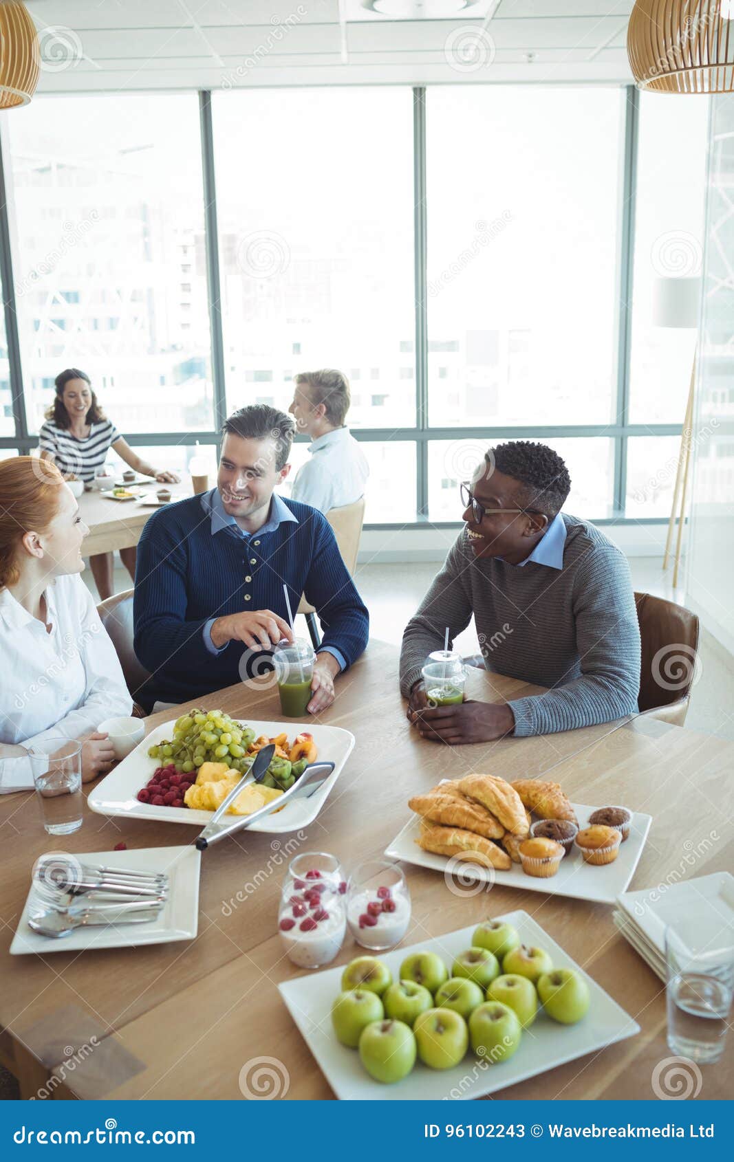Smiling Business Colleagues Having Breakfast at Office Cafeteria Stock ...