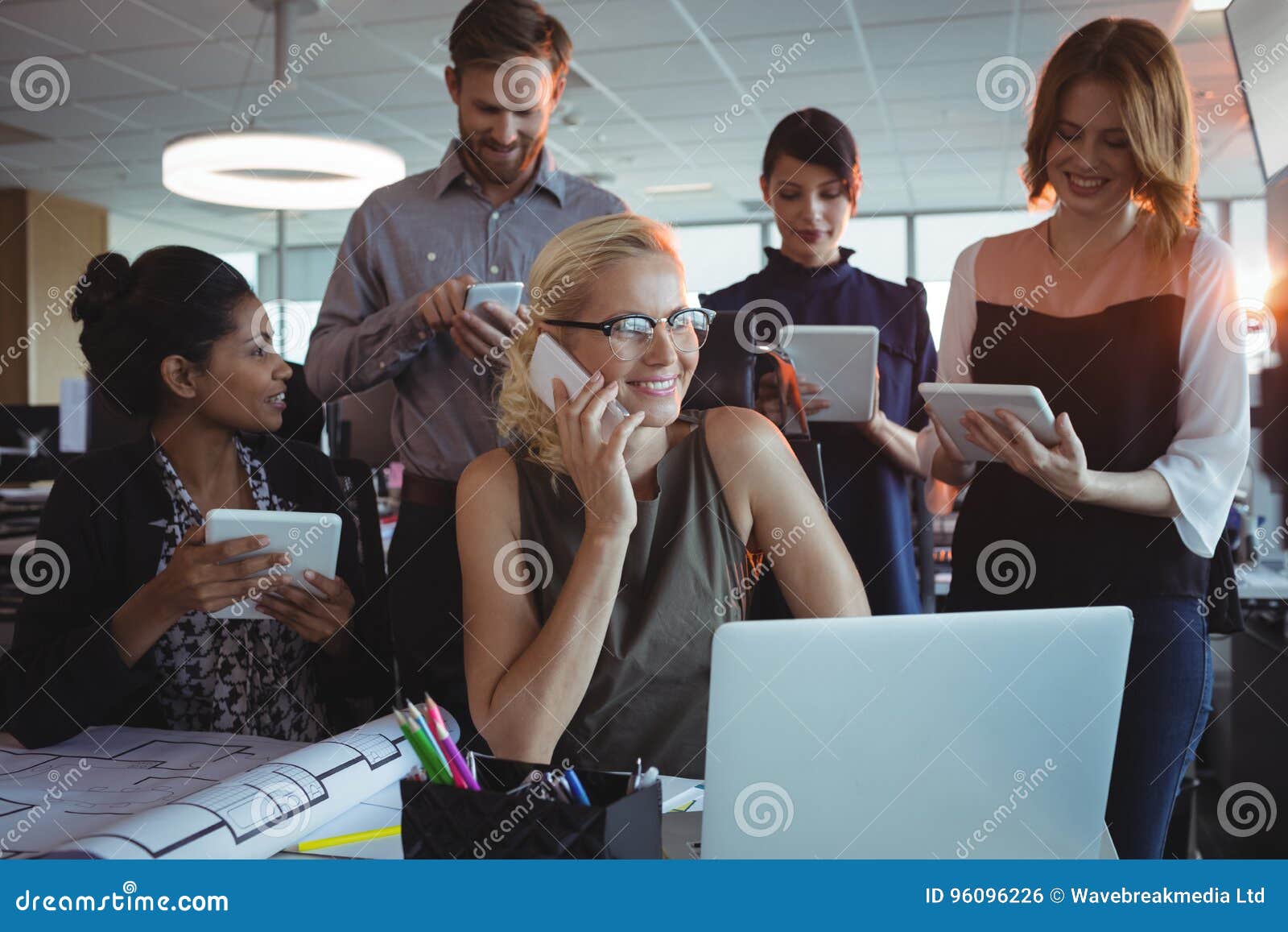 Smiling Business Colleagues Using Mobile Phones and Digital Tablets ...