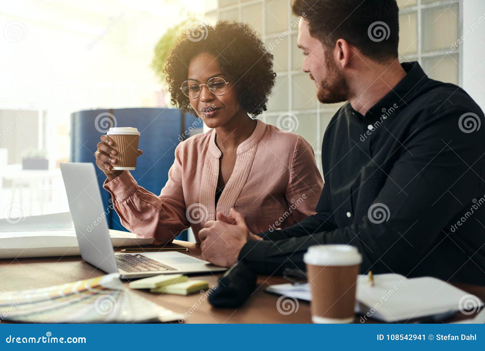Smiling Business Colleagues Working with a Laptop in an Office Stock ... Smiling Business Colleagues Working with a Laptop in an Office Stock ...