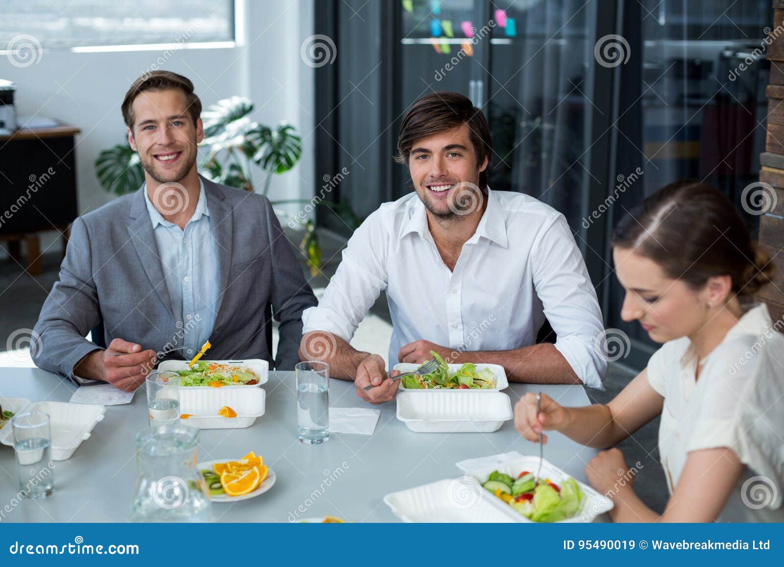 Smiling Business Executive Having Meal in Office Stock Image - Image of ...