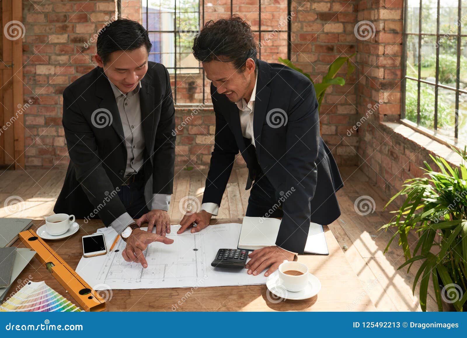 Coworkers Discussing Project Stock Image - Image of explaining, smiling ...