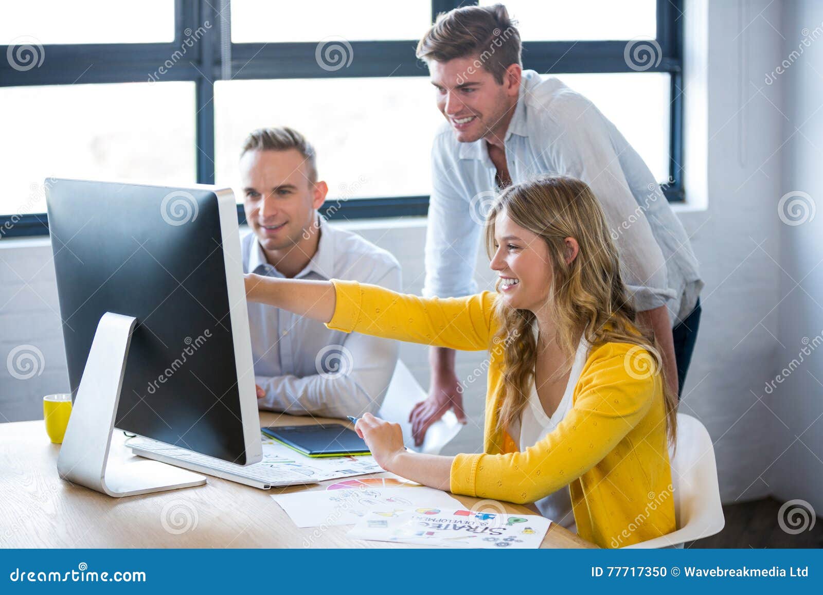 Smiling Business People Discussing Over Computer Stock Photo - Image of ...