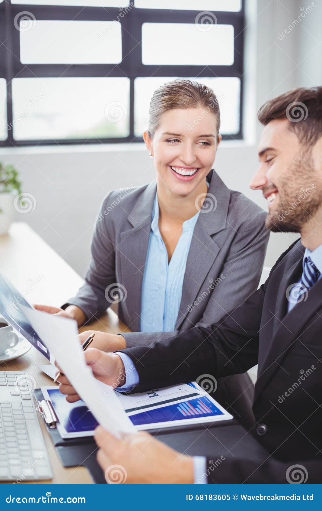Smiling Business People Discussing Over Documents Stock Image - Image ...