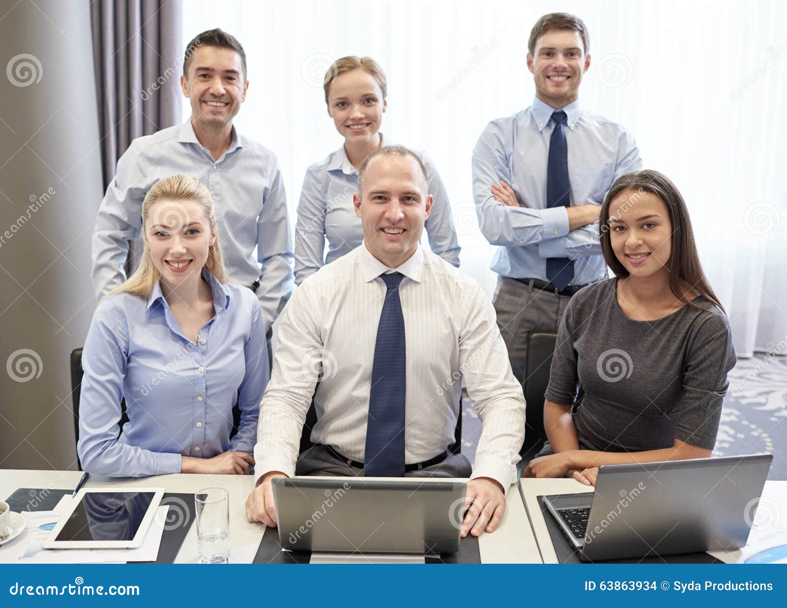 Smiling Business People with Laptop in Office Stock Photo - Image of ...