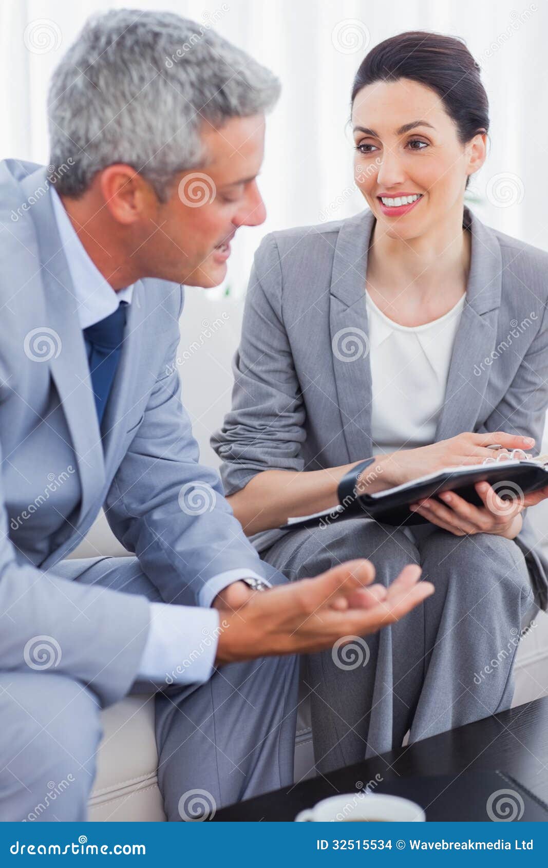 Smiling Business People Working and Talking Together on Sofa Stock ...