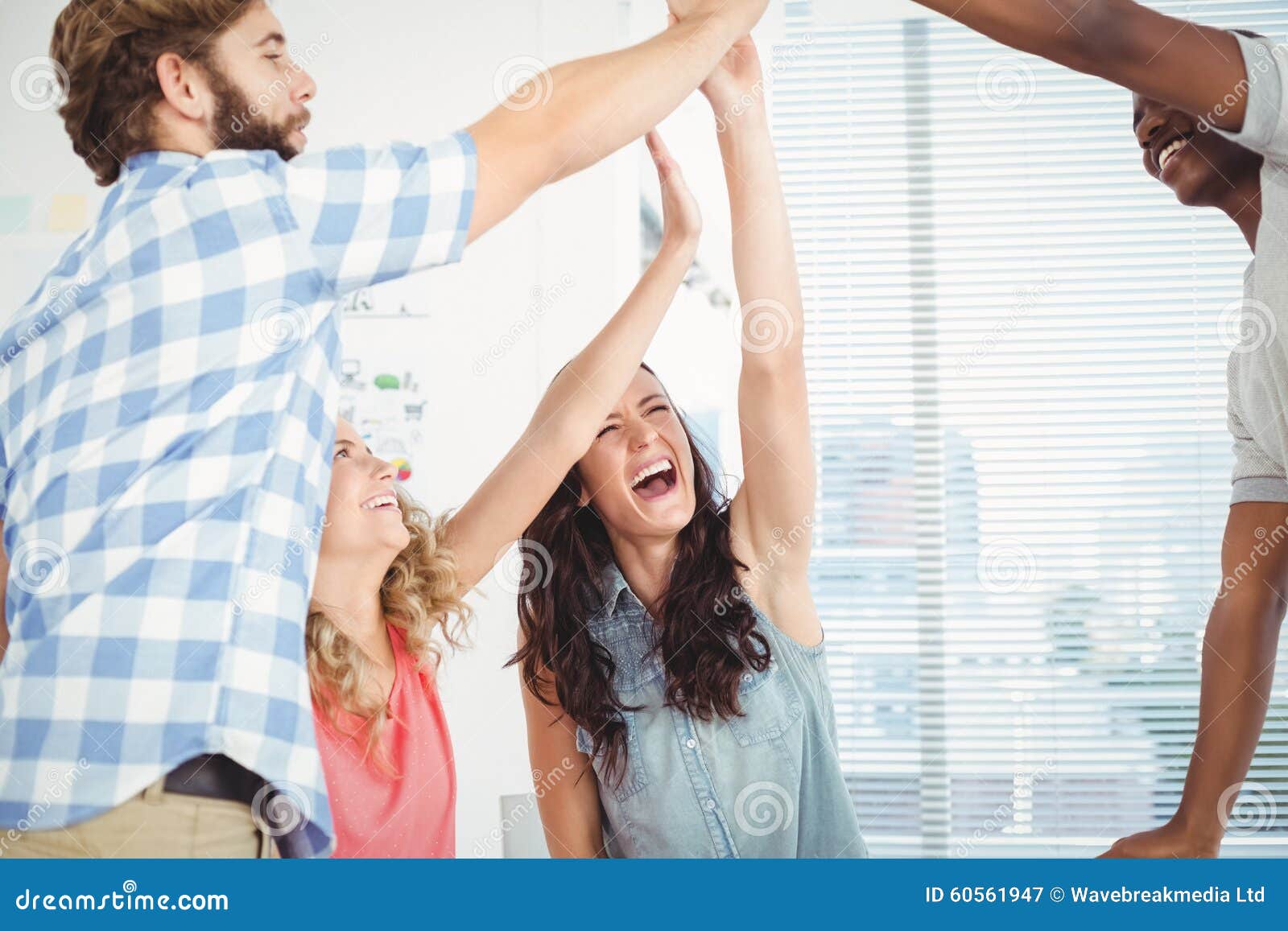 Smiling Business Professionals Giving High Five at Desk Stock Image ...
