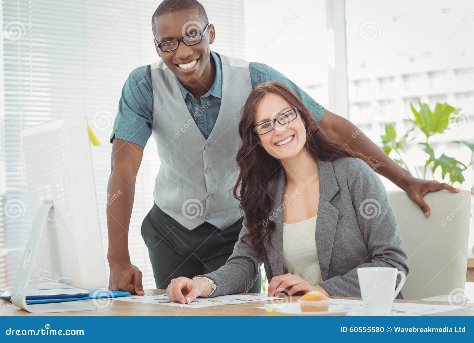 Smiling Business Professionals Working at Computer Desk Stock Photo ...