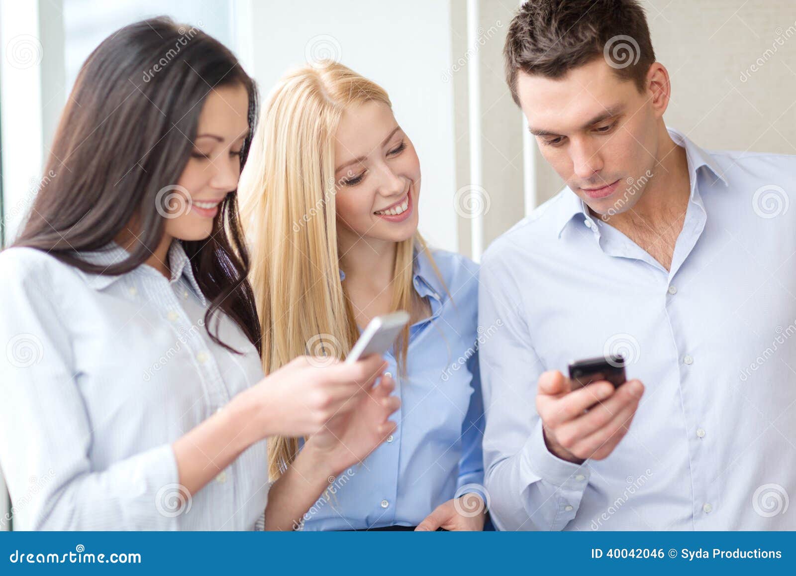 Smiling Business Team with Smartphones in Office Stock Photo - Image of ...