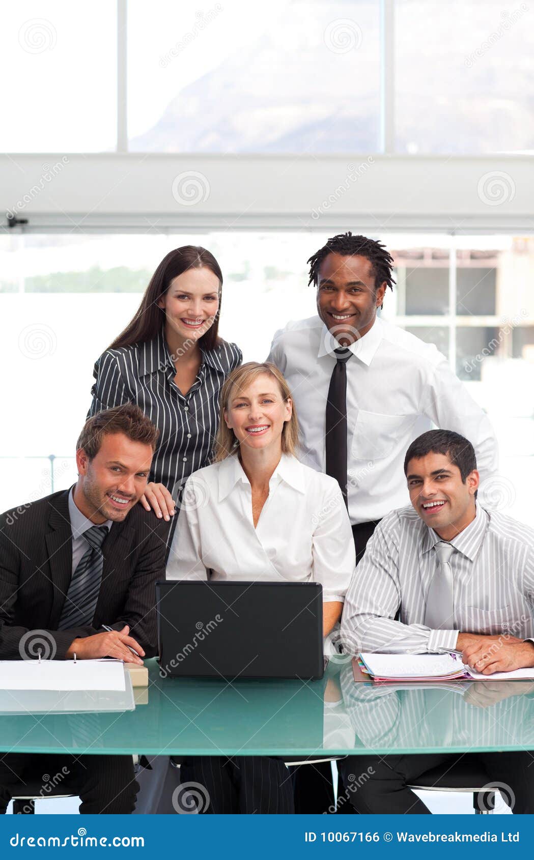 Smiling Business Team Working Together with a Lapt Stock Photo - Image ...