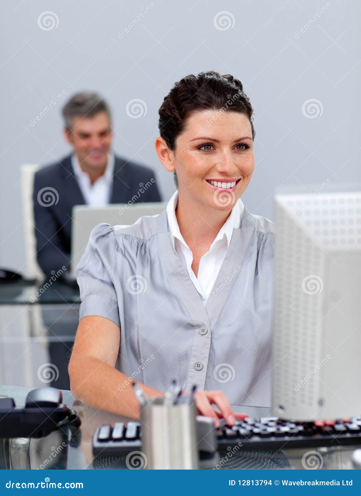Smiling Business Woman Working at a Computer Stock Photo - Image of ...