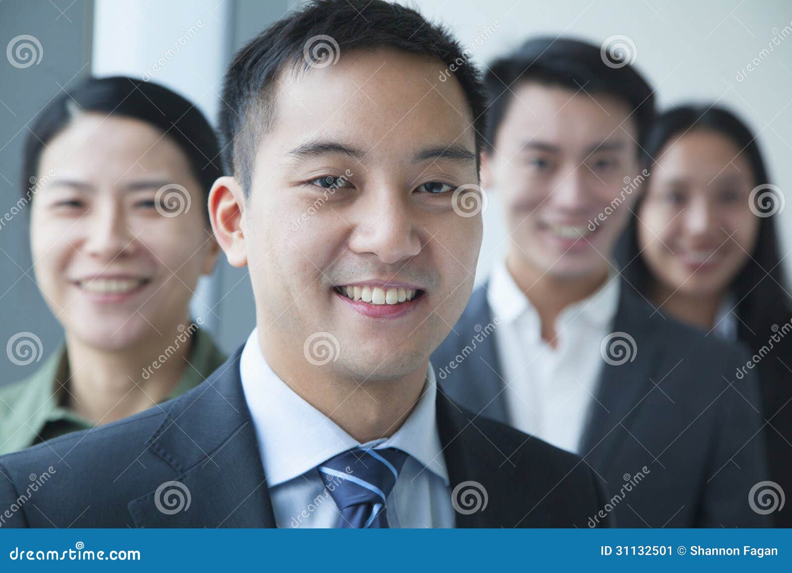 Smiling Businessman with Co-workers in Office Portrait Stock Image ...