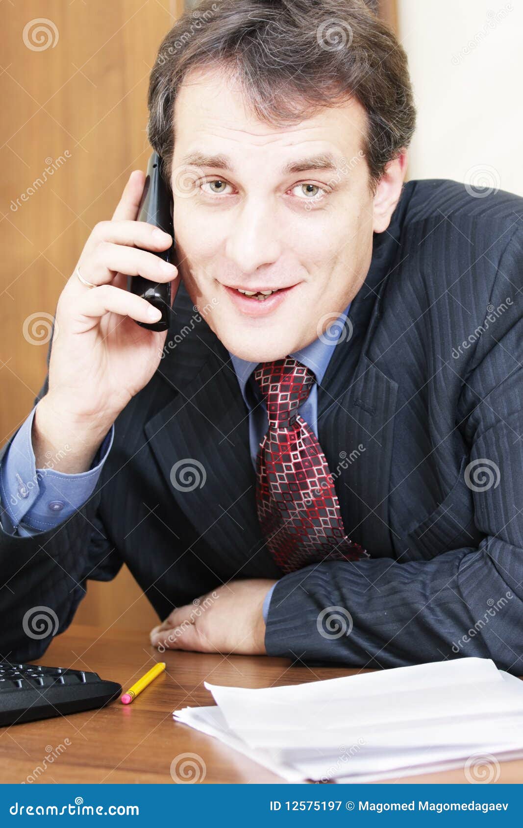 Smiling Businessman at Desk with Phone Stock Image - Image of portrait ...