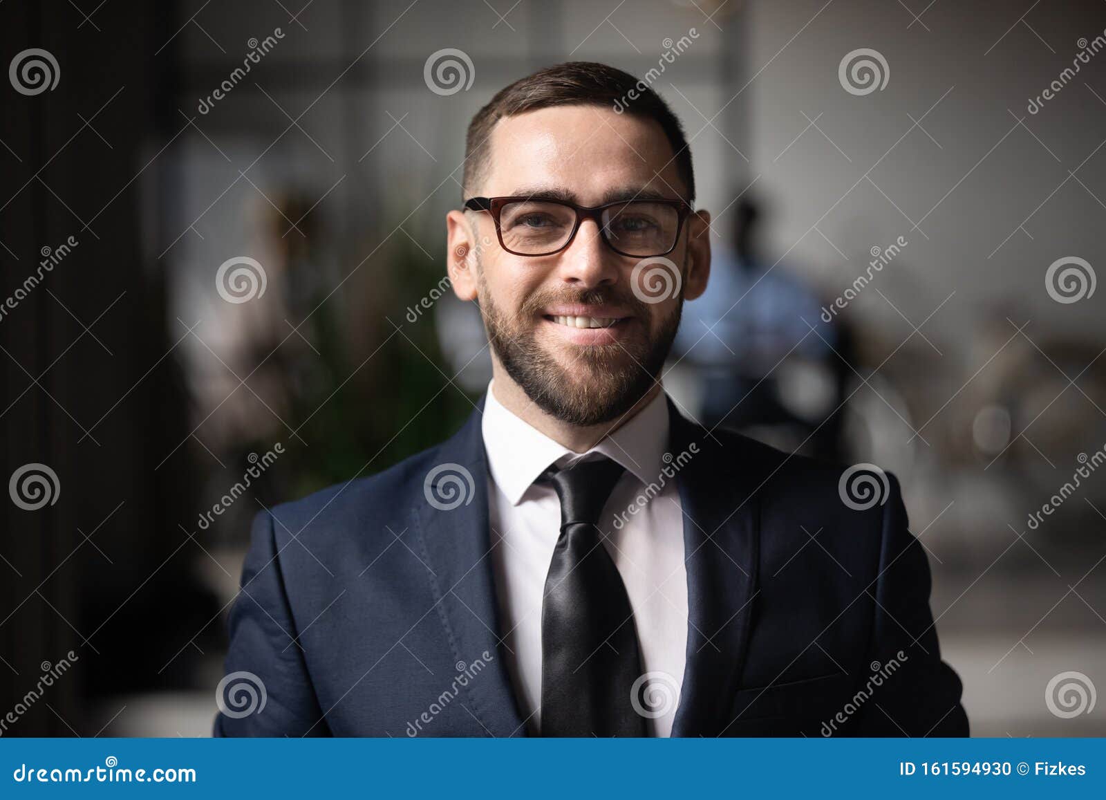 Smiling Businessman Executive Looking At Camera In Office Business
