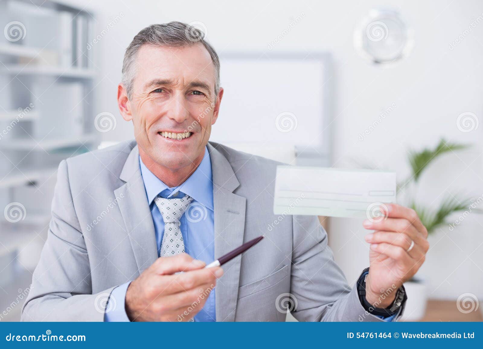 Smiling Businessman Holding Cheque Stock Photo - Image of businessman ...