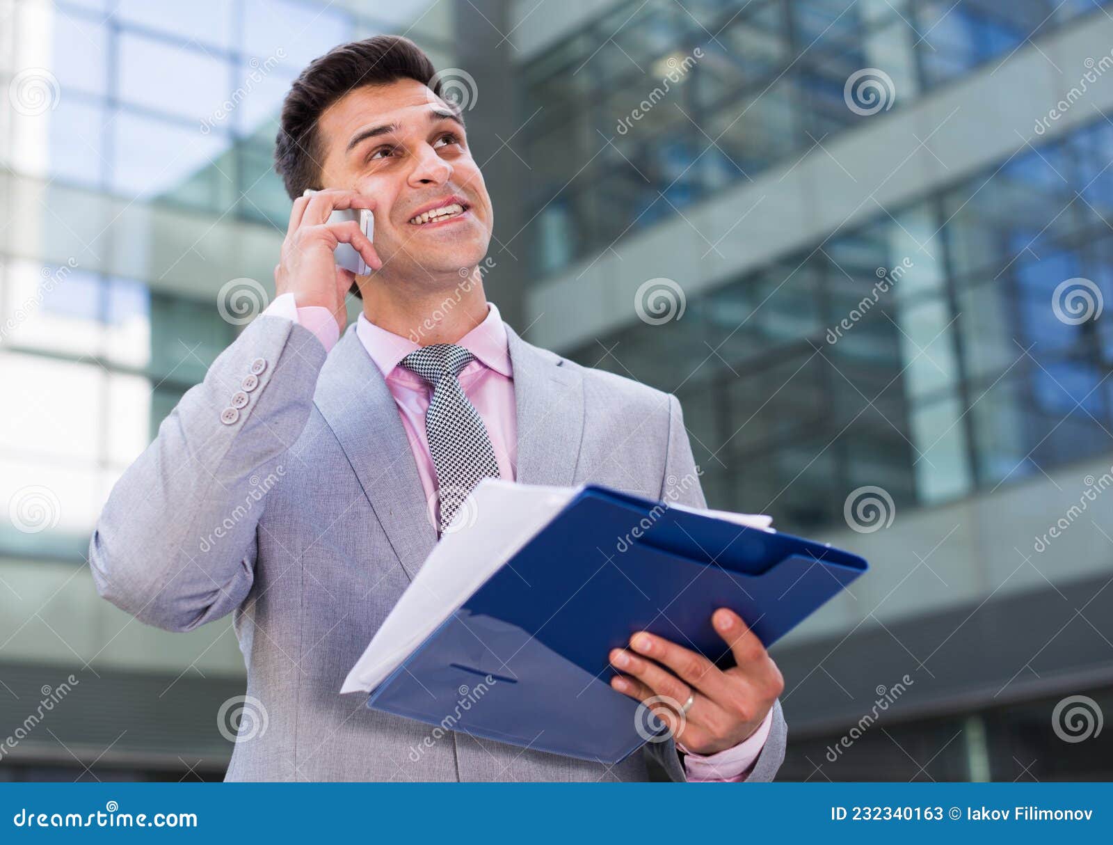 Smiling Businessman with Papers Talking on Phone Stock Image - Image of ... Smiling Businessman with Papers Talking on Phone Stock Image - Image of ...