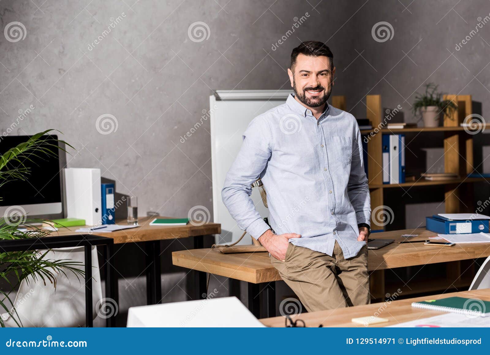 Smiling Businessman Leaning on Table in Office and Looking Stock Image ...