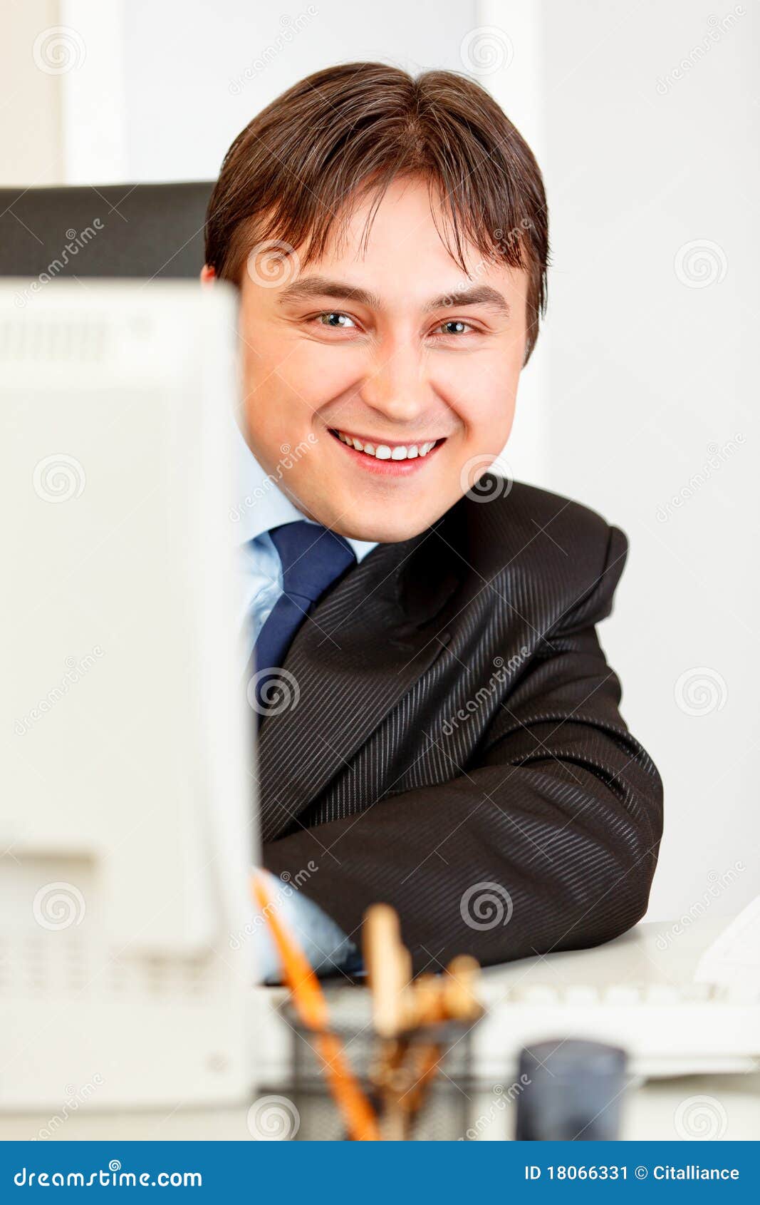 Smiling Businessman Looking from Computer Monitor Stock Image - Image ...