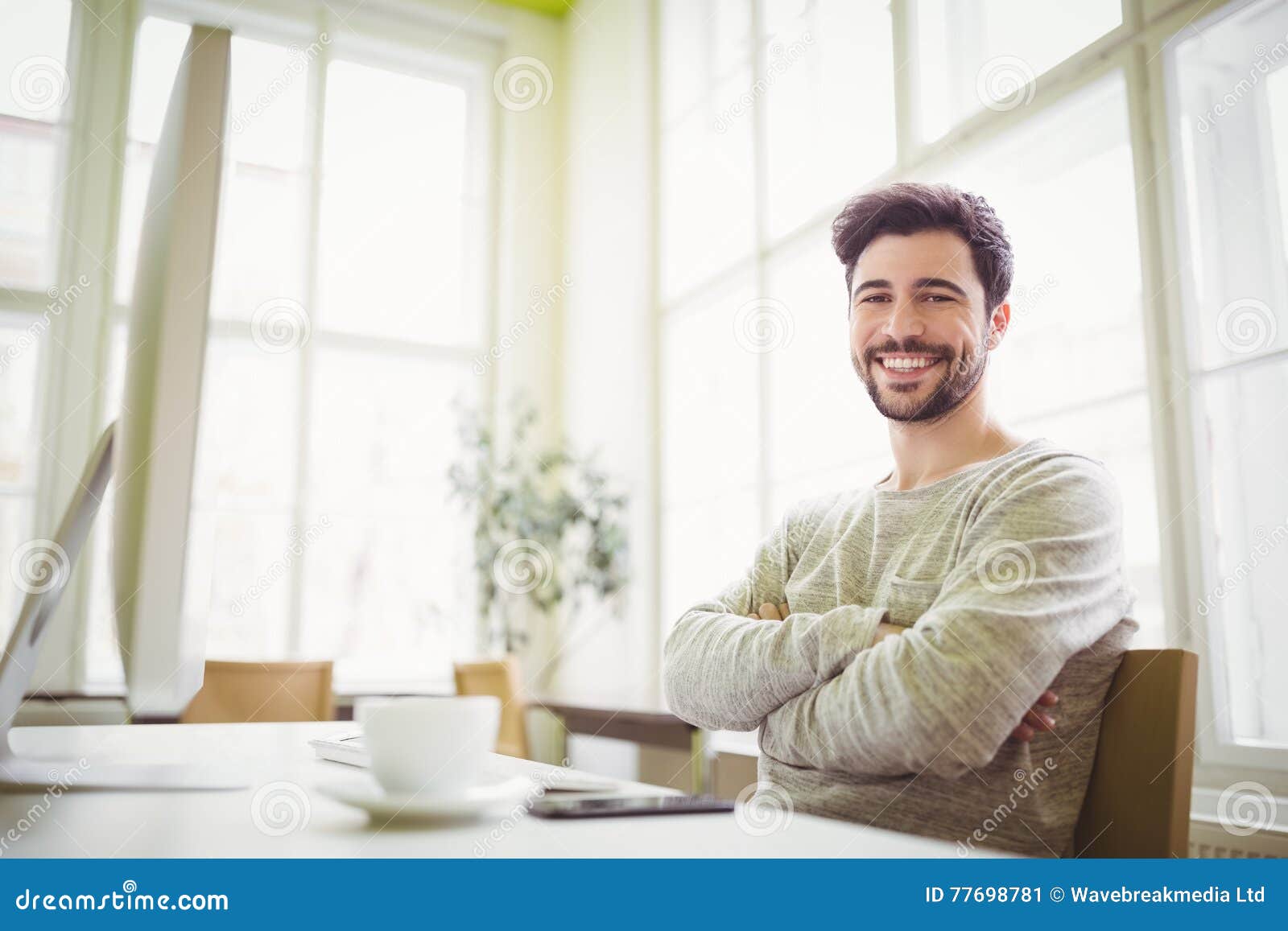 Smiling Businessman Sitting at Desk in Office Stock Image - Image of ...