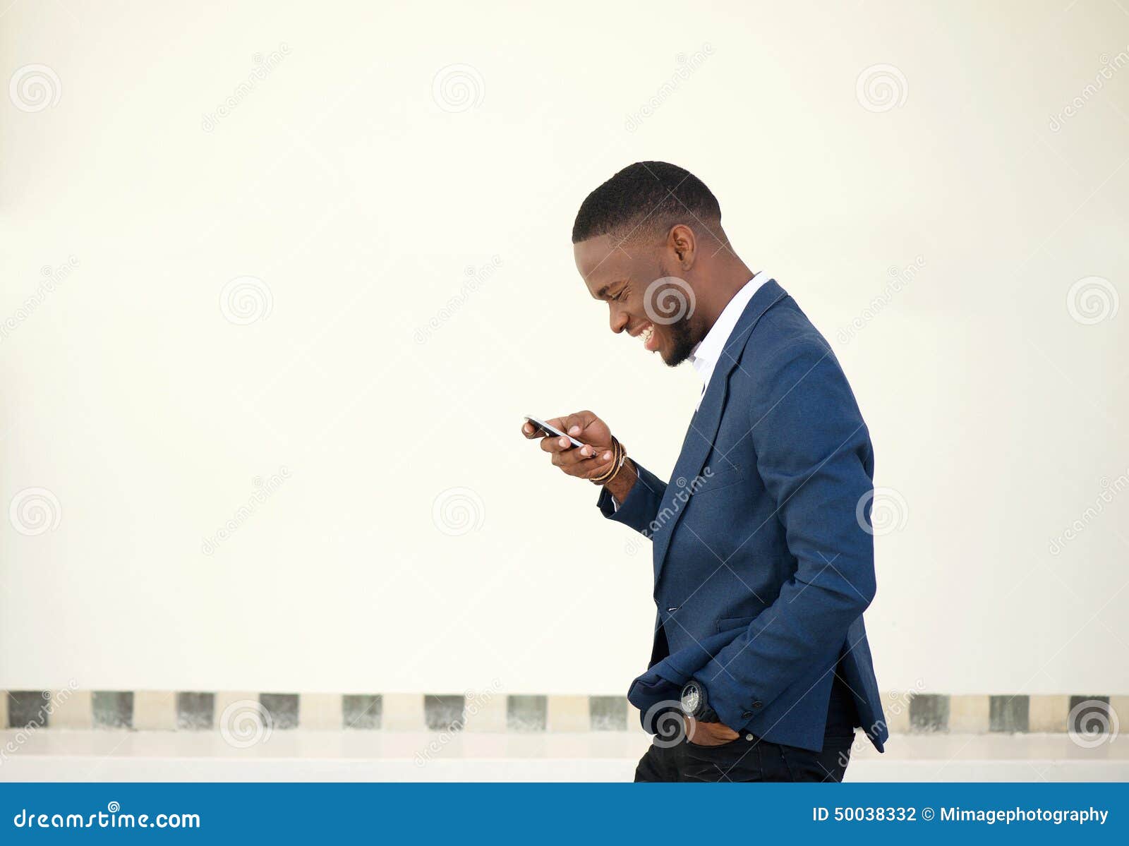Smiling Businessman Walking and Sending Text Message Stock Photo ...