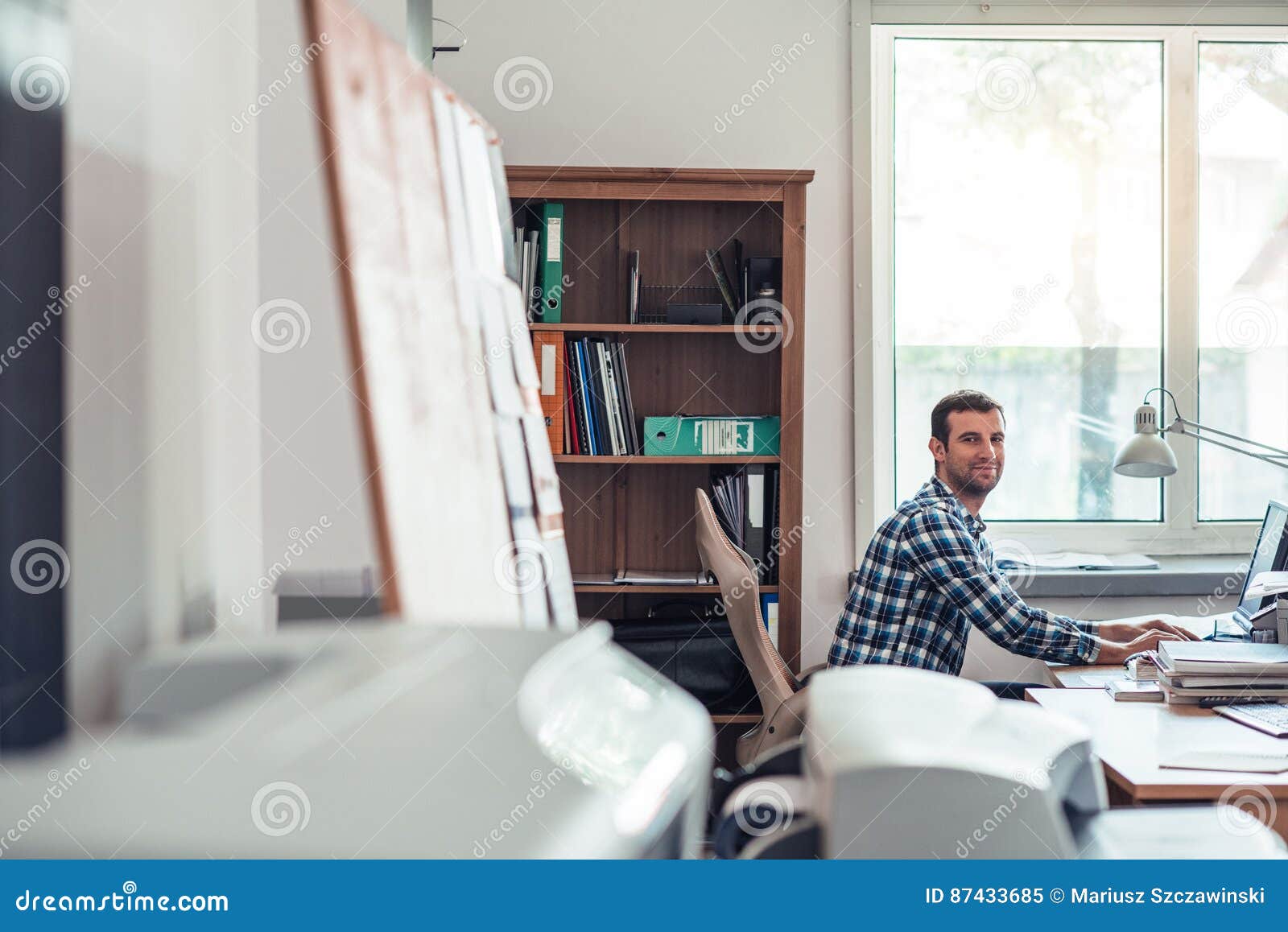 Smiling Businessman Working on a Computer in an Office Stock Image ...