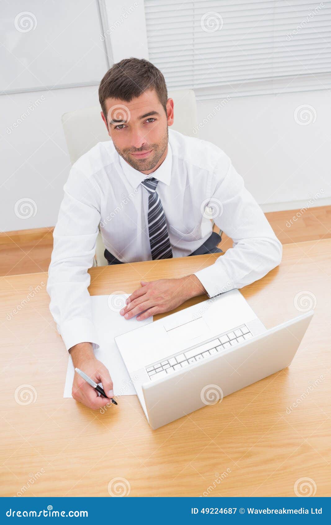 Smiling Businessman Writing at His Desk Stock Image - Image of adult ...