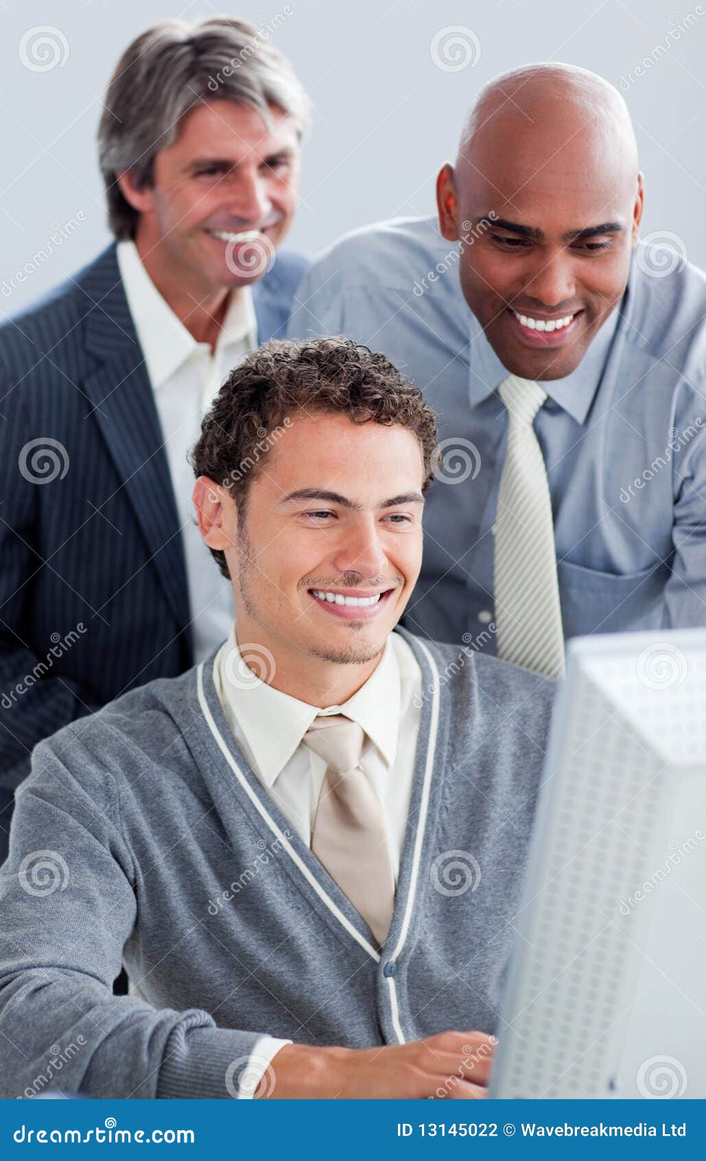 Smiling Businessmen Working at a Computer Stock Photo - Image of ...