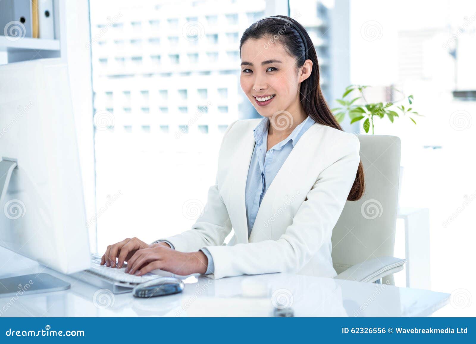Smiling Businesswoman Typing on Keyboard Stock Photo - Image of classy ...