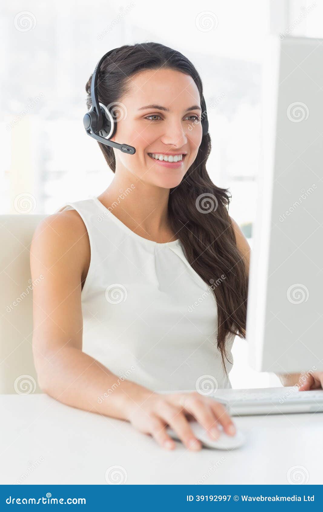 Smiling Call Centre Agent Sitting at Her Desk on a Call Stock Image ...