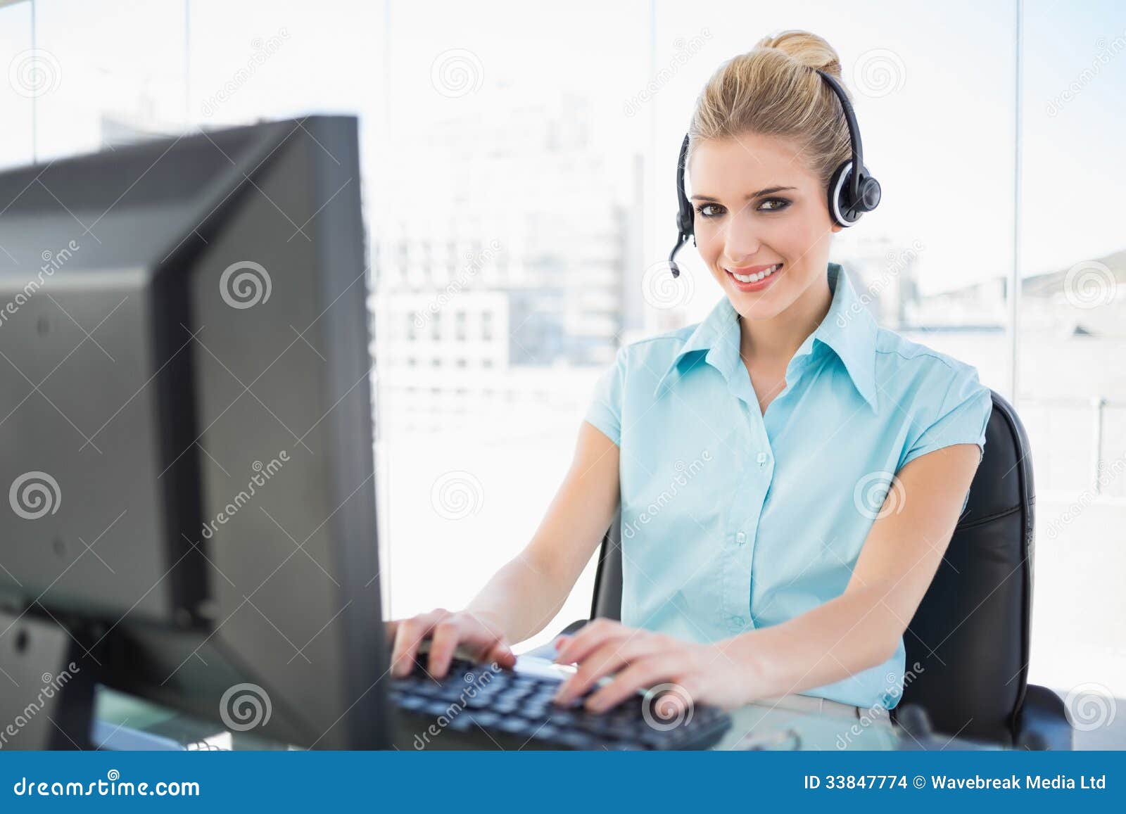 Smiling Call Centre Agent Working on Computer Stock Photo - Image of ...