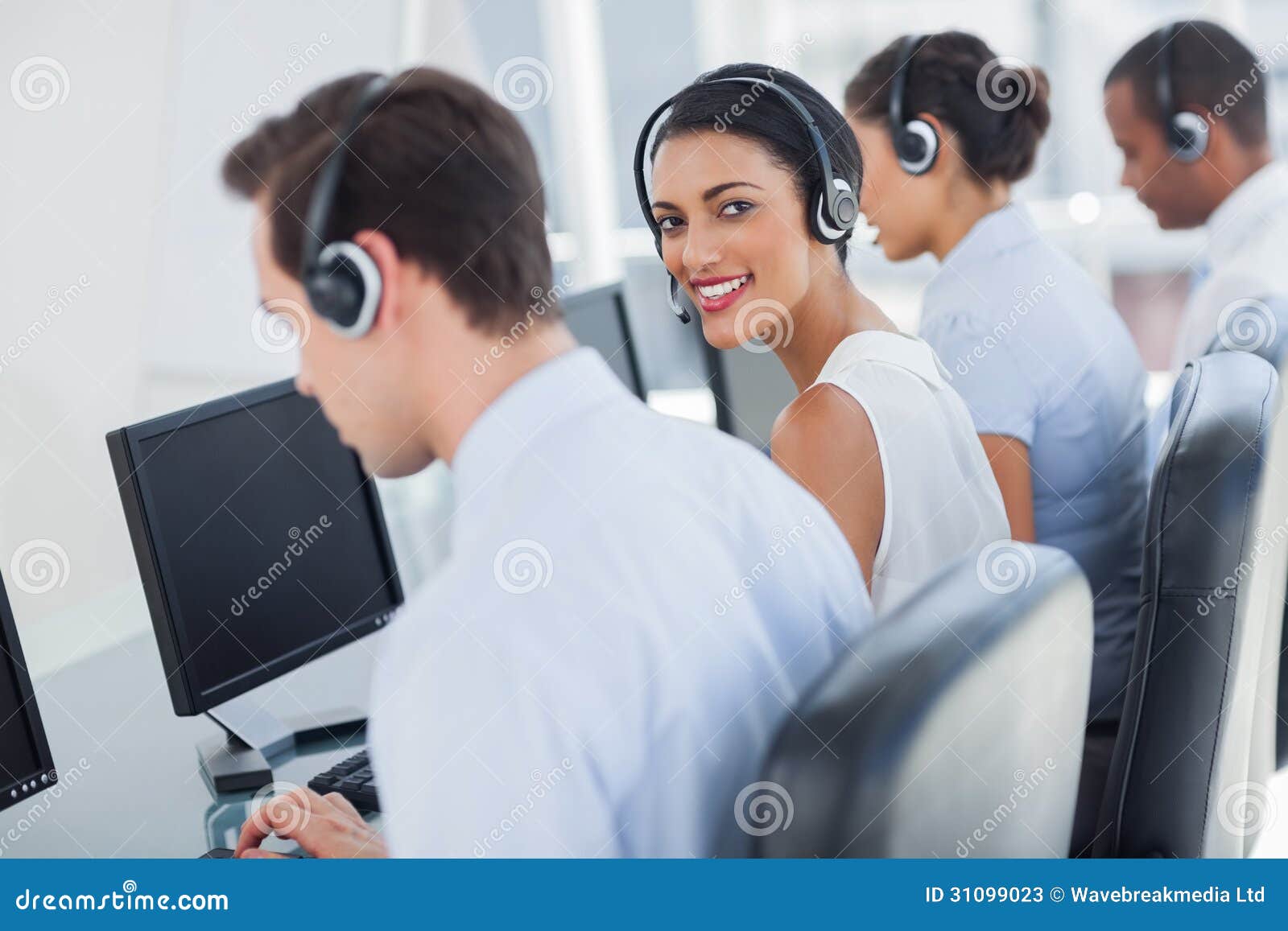 Smiling Call Centre Employee Looking Over Shoulder Stock Image - Image ...