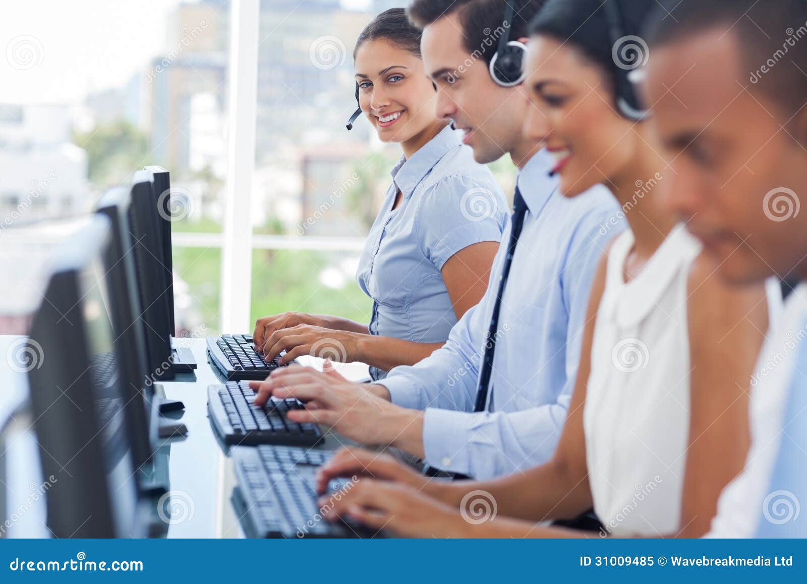 Smiling Call Centre Employees Working on Computers Stock Image - Image ...