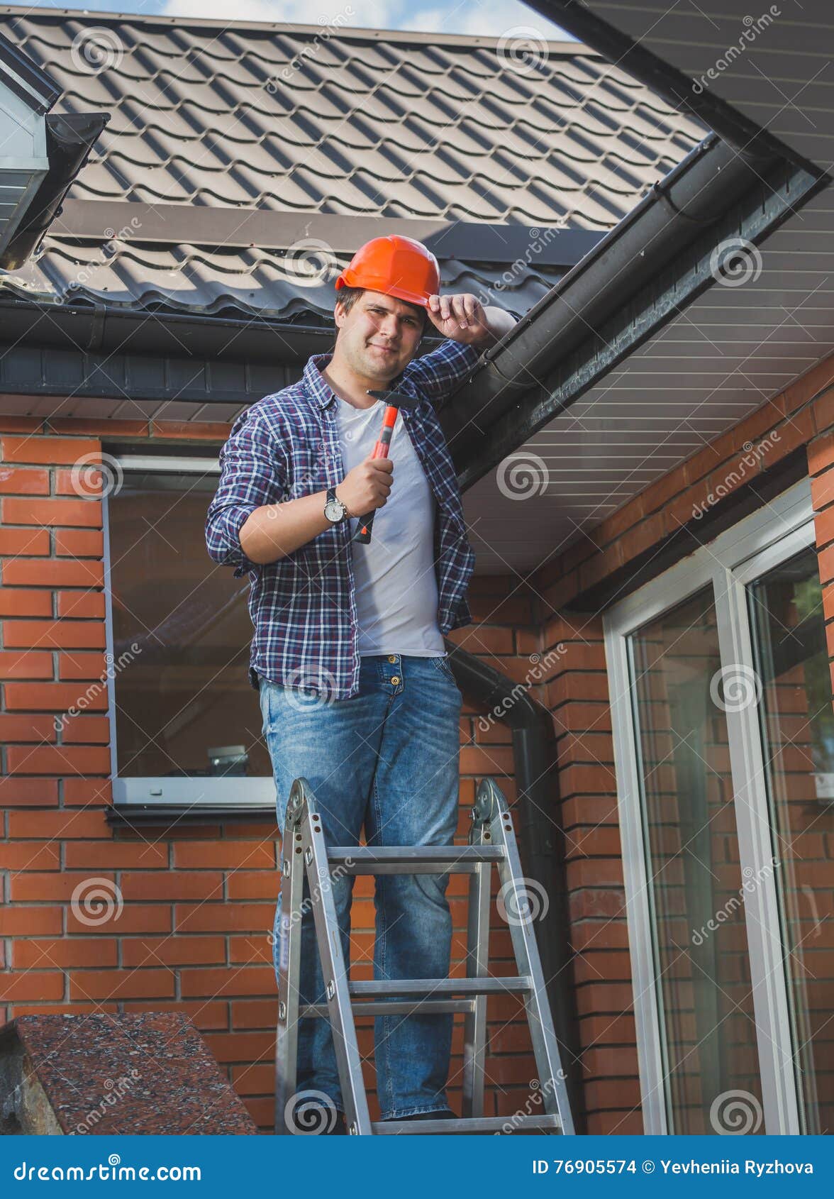 Smiling Carpenter Posing with Hammer on Step Ladder Under the Roof ...