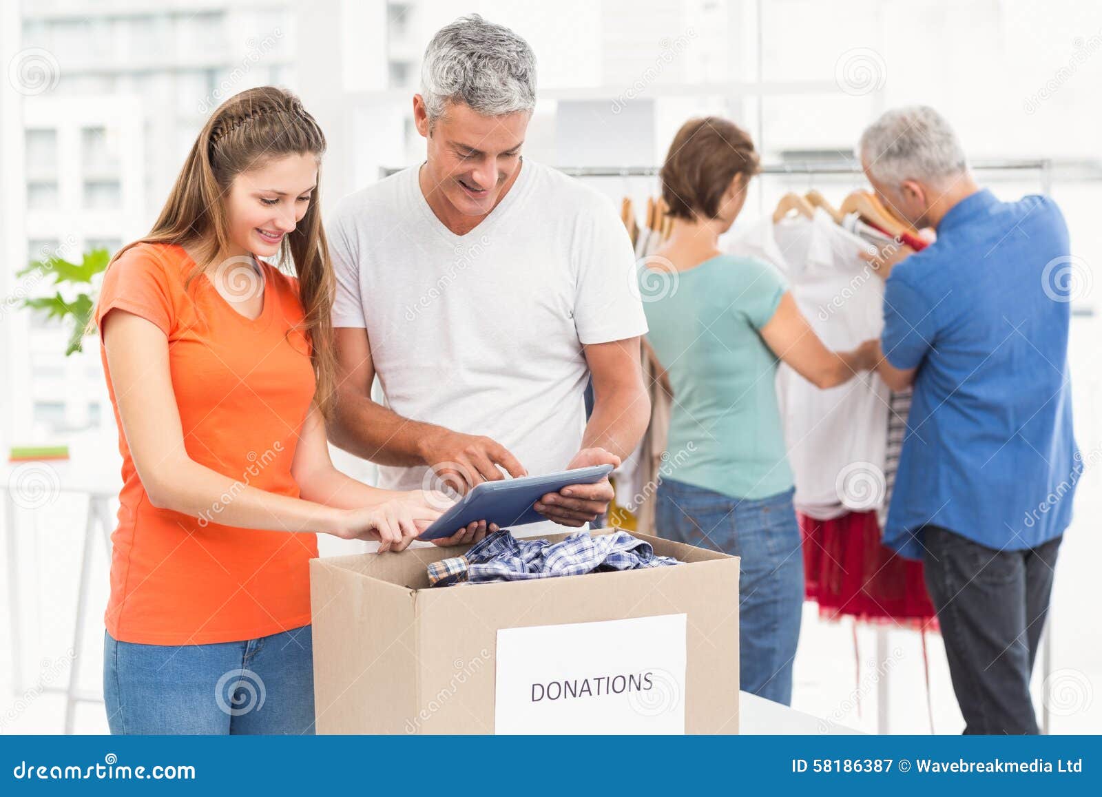 Smiling Casual Business People Sorting Donations Stock Image - Image of ...