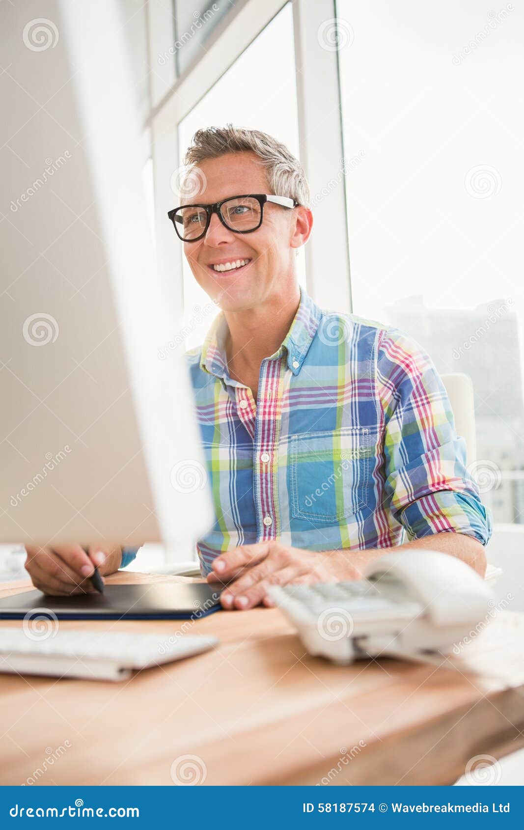 Smiling Casual Designer Using Computer and Digitizer Stock Photo ...