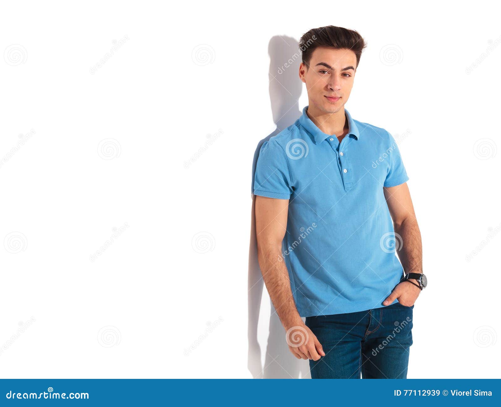 Smiling Casual Man Leaning His Shoulder on White Wall Stock Image ...