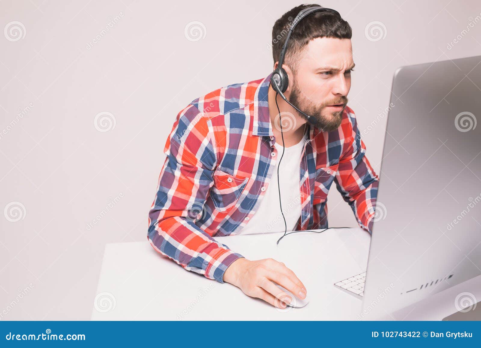 Casual Young Man with Headset Using Computer in a Bright Office Stock ...