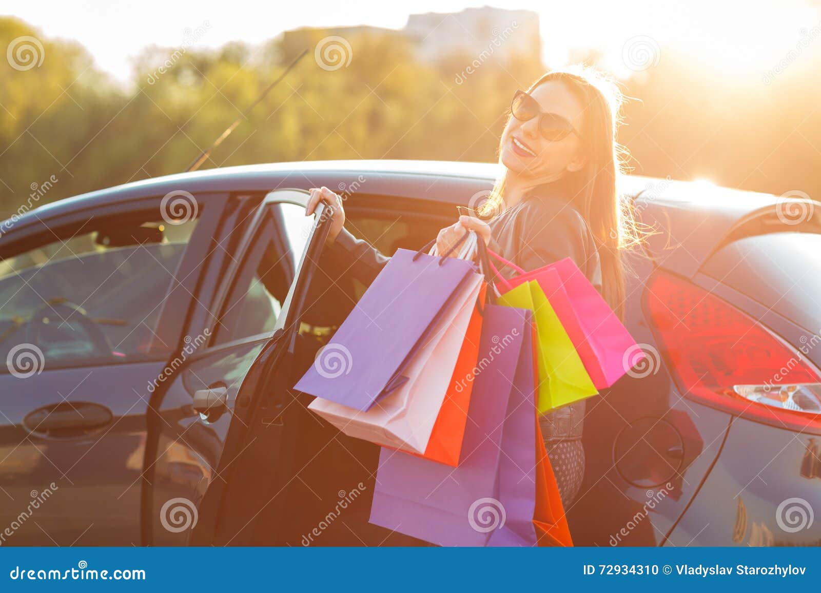 Smiling Caucasian Woman Putting Her Shopping Bags Into The Car Stock