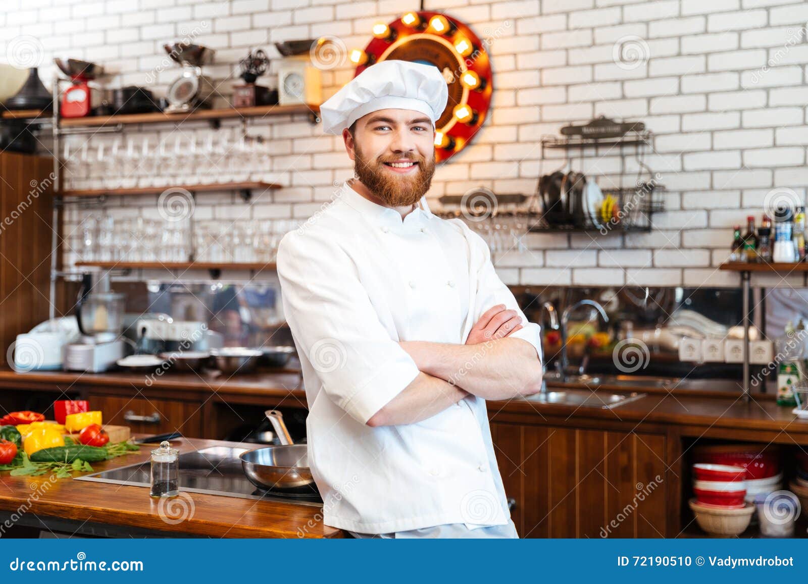 Smiling Chef Cook Standing with Hands Folded on the Kitchen Stock Photo ...