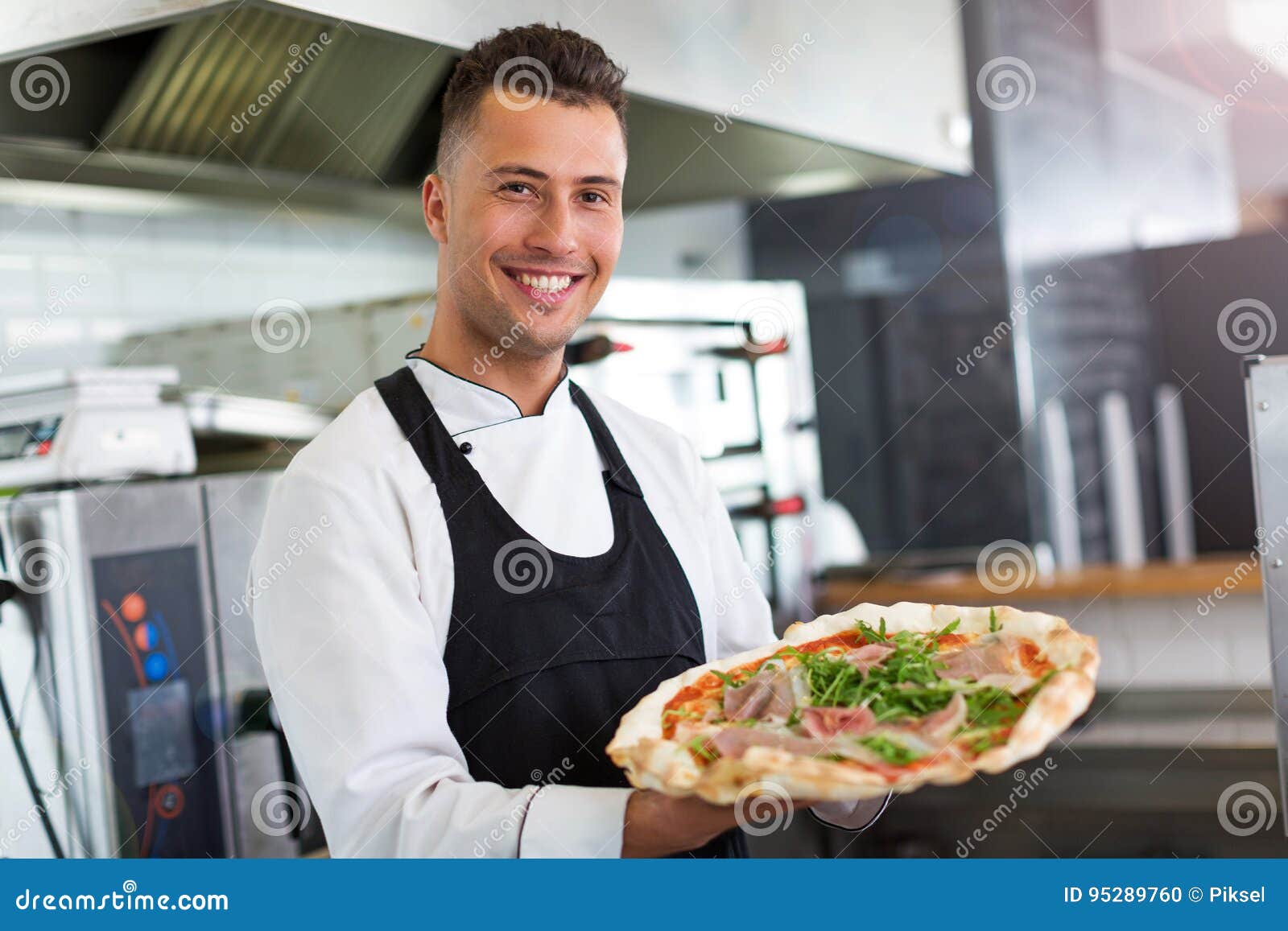 Smiling Chef Holding Fresh Pizza in Kitchen Stock Photo - Image of ...