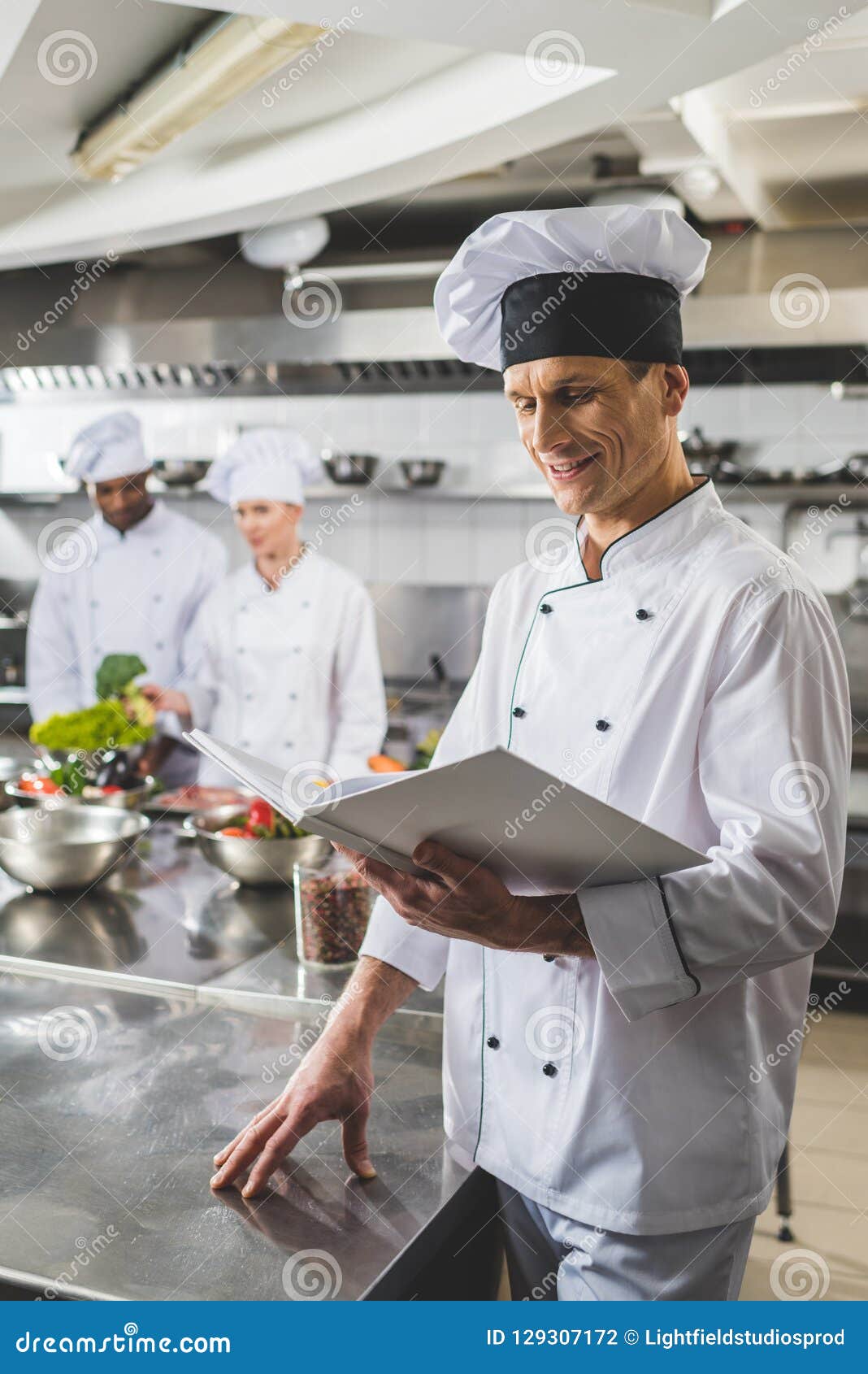 Smiling Chef Reading Recipe Stock Photo - Image of people, nutrition ...