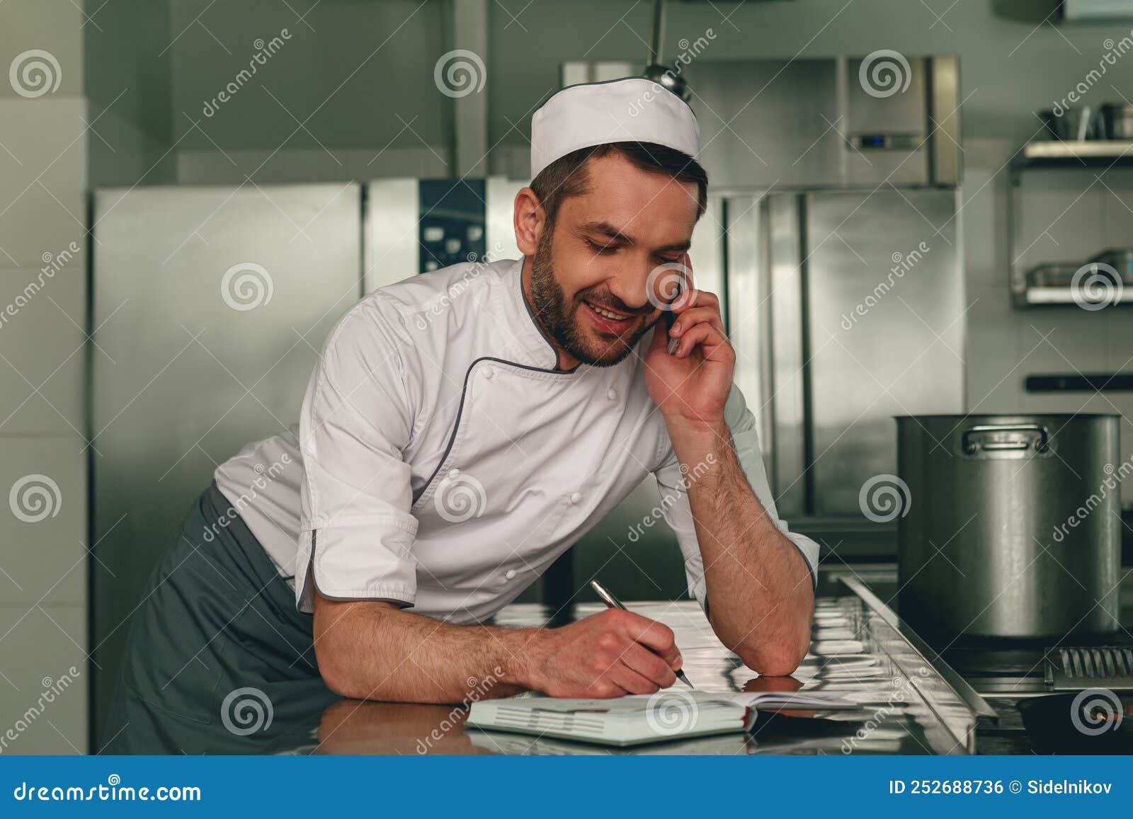 Smiling Chef in Uniform Making Order for the Supplier Standing on ...