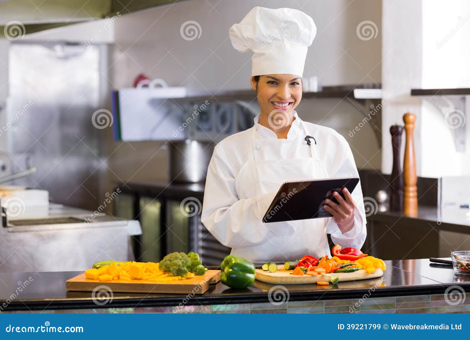 Smiling Chef Using Digital Tablet while Cutting Vegetables Stock Image ...