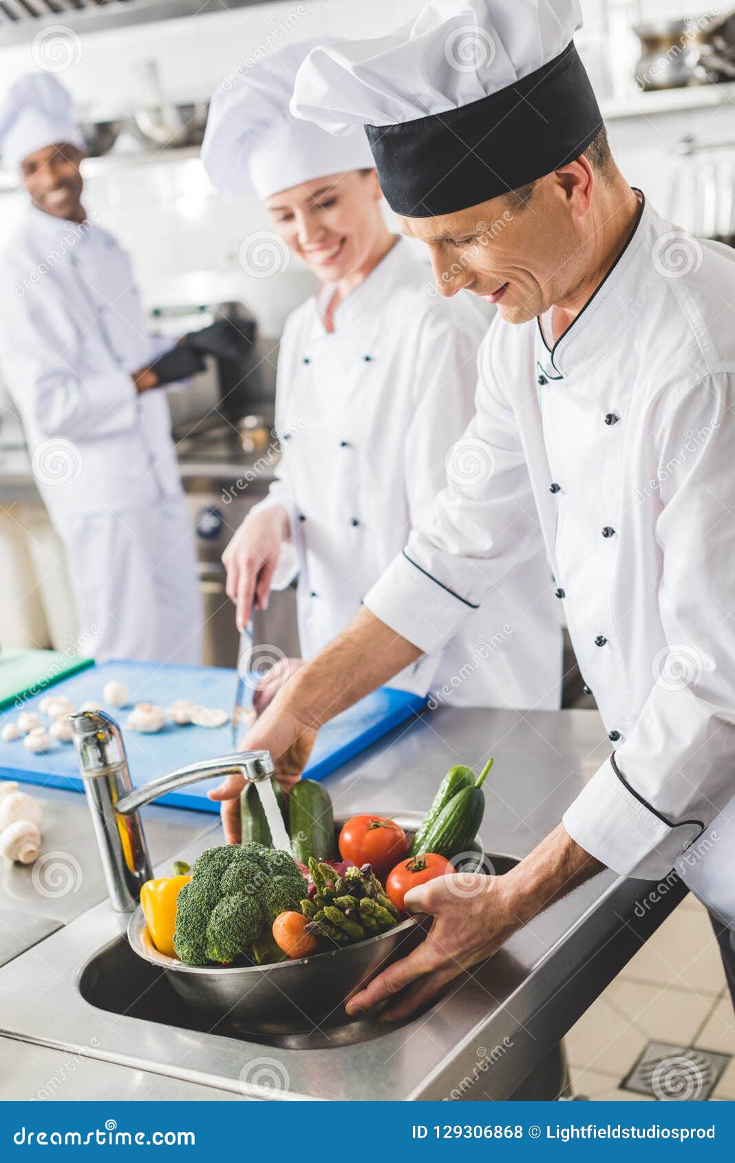 Smiling Chef Washing Vegetables Stock Photo - Image of blackman, chefs ...