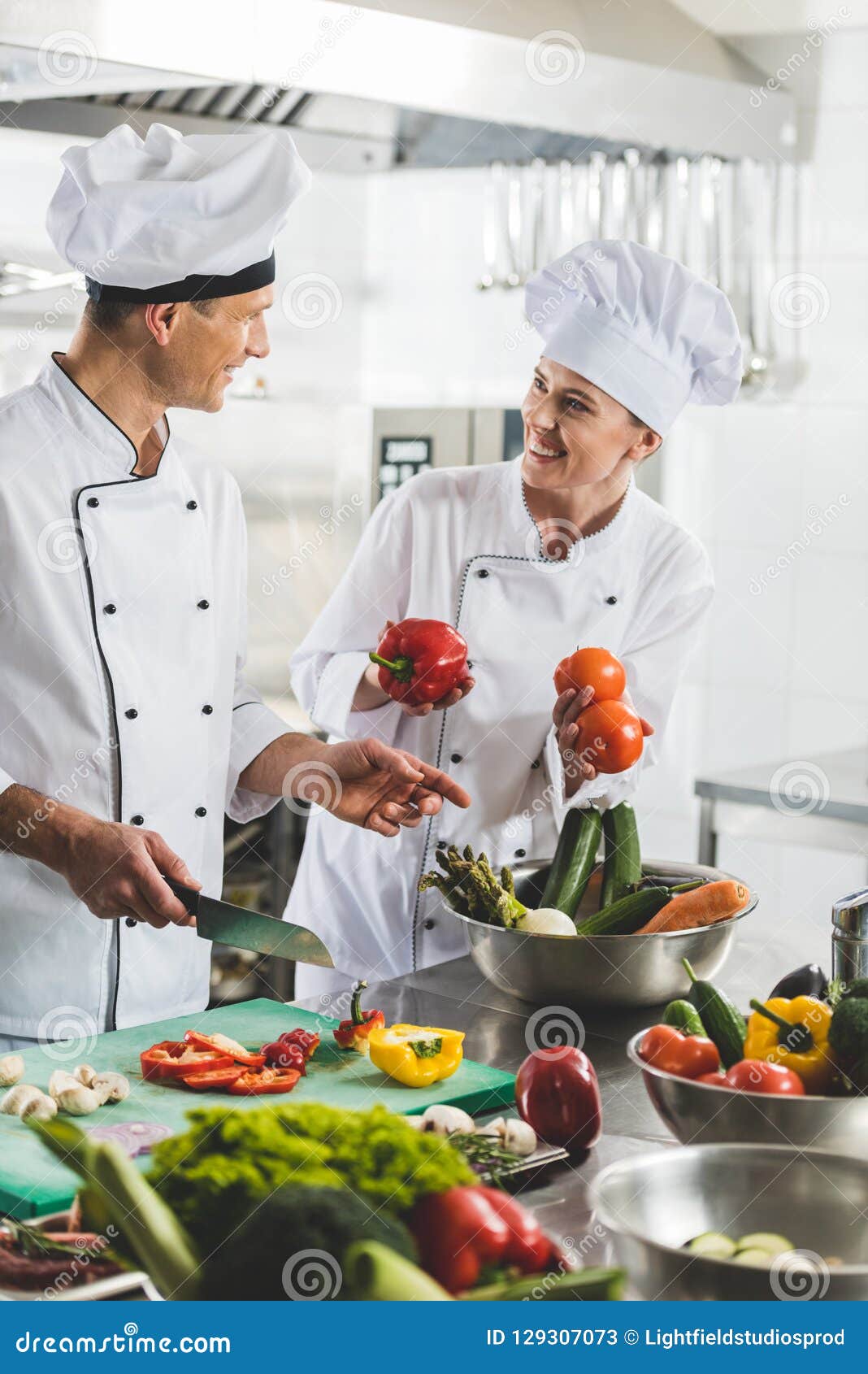 Smiling Chefs Cooking and Looking at Each Other Stock Image - Image of ...