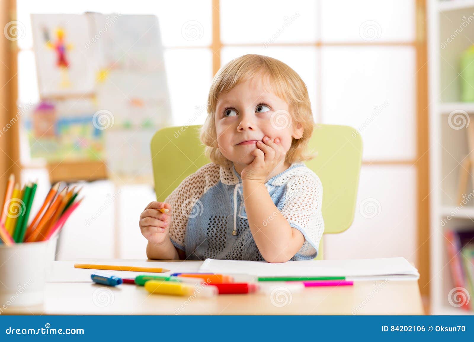 Smiling Child Having an Idea while Drawing in Nursery Room Stock Photo ...
