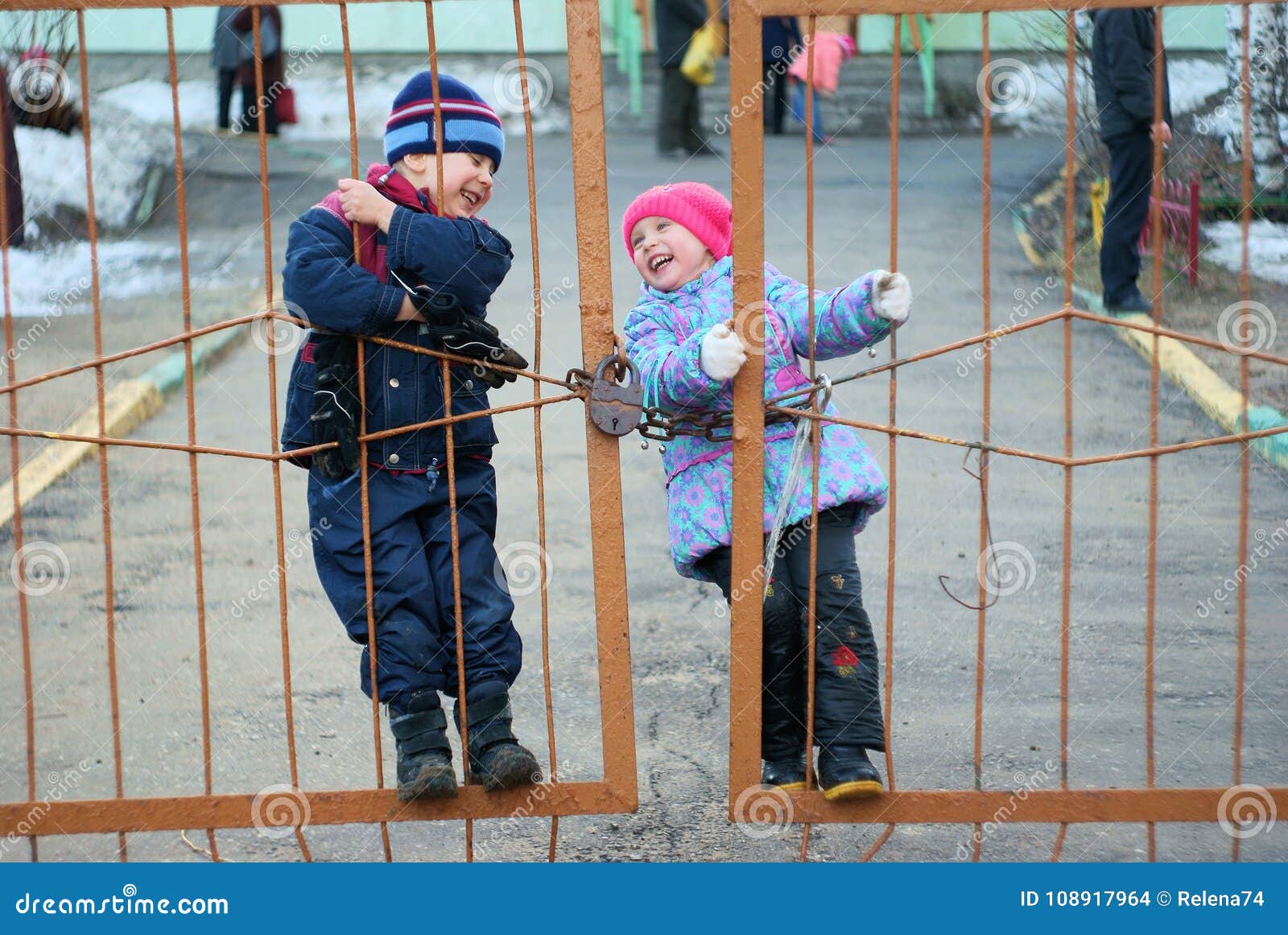 Smiling Children Have Fun Swinging on the Gate Stock Photo - Image of ...