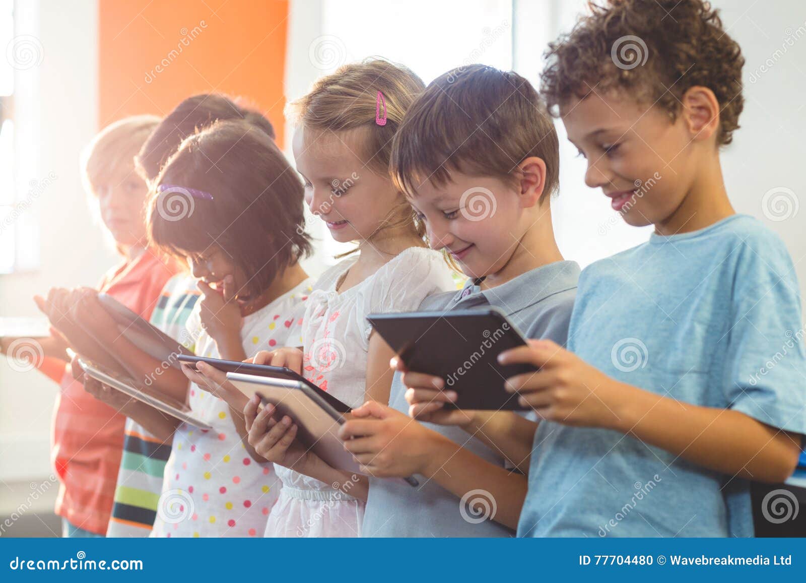 Smiling Children Using Digital Tablets Stock Photo - Image of early ...